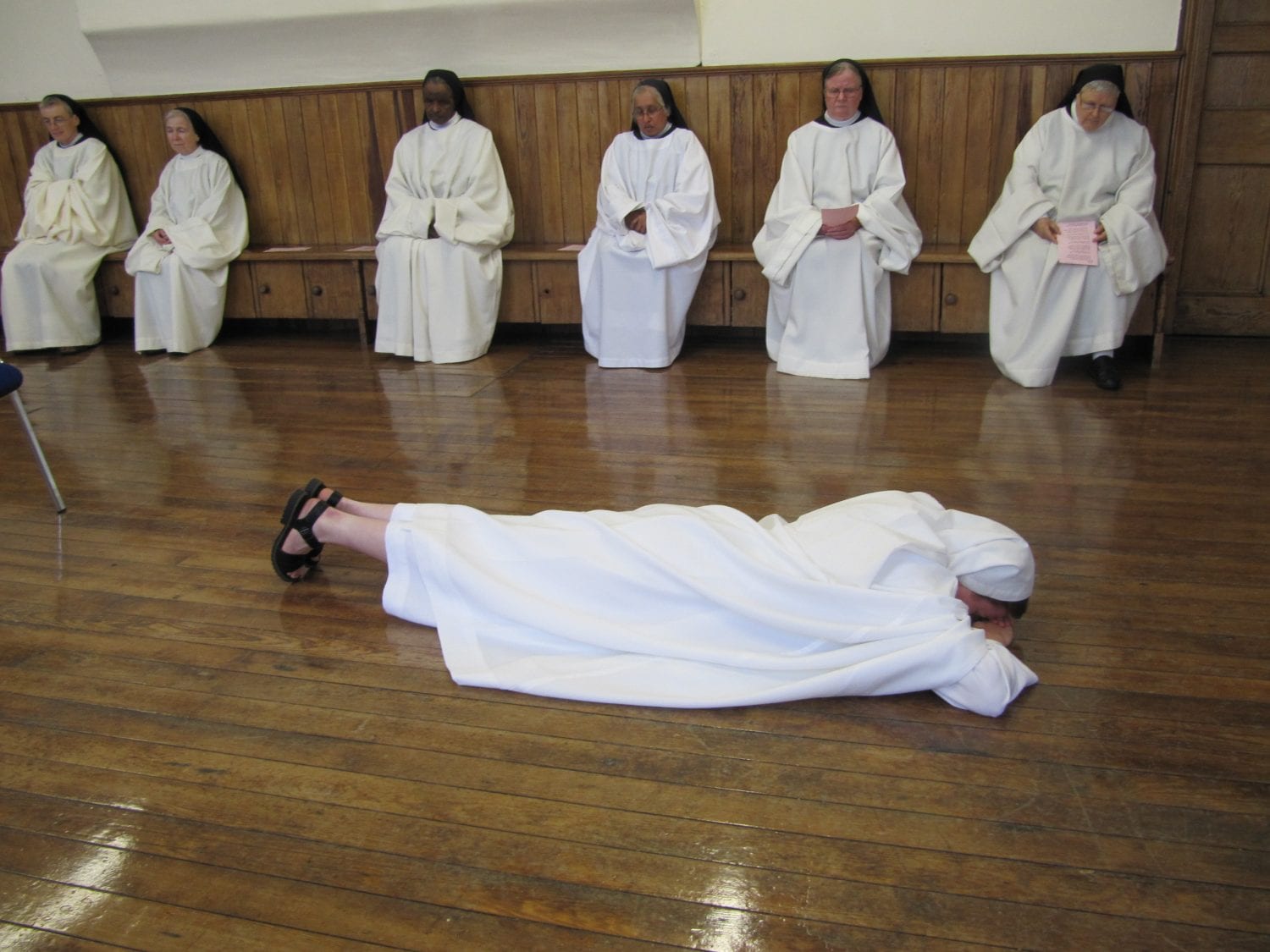 Sister Beatrice prostrates before the Abbess in a gesture of self-offering.